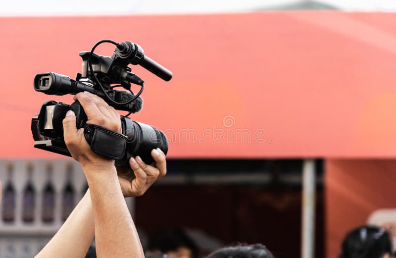 Hands of Professional Video Camera Operator Working with His Equipment ...