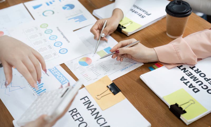Hands of Professionals Collaborating on Financial Reports and Data ...