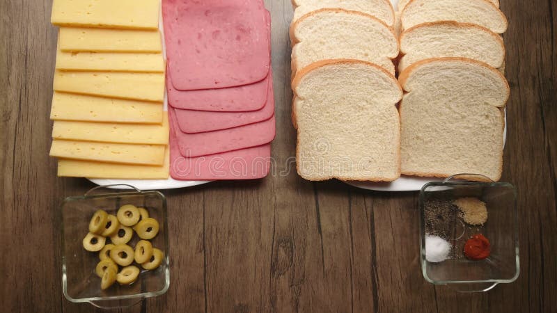Hands Put Various Ingredients for Making a Sandwich on the Table Stock ...