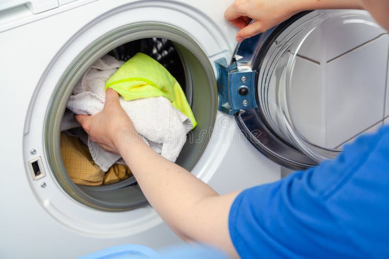 Hands Putting Laundry in the Washing Machine Stock Photo - Image of ...