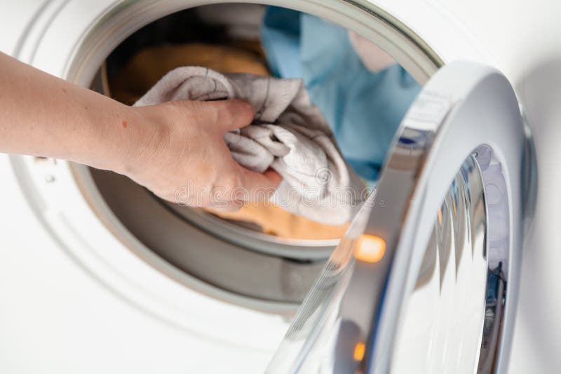 Hands Putting Laundry in the Washing Machine Stock Photo - Image of ...