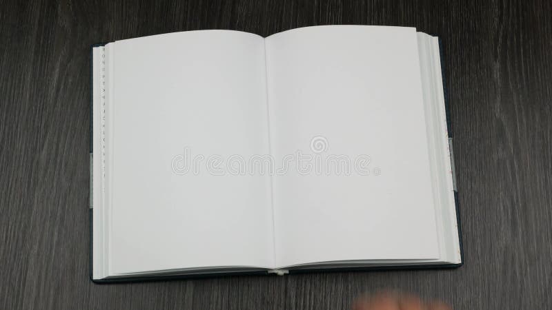 Hands Putting an Opened Book on the Table. Top View Stock Footage ...
