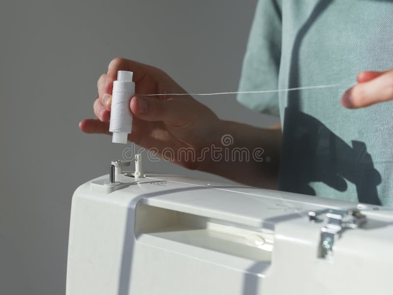 Hands Putting Thread Spool on Sewing Machine Stock Photo - Image of ...