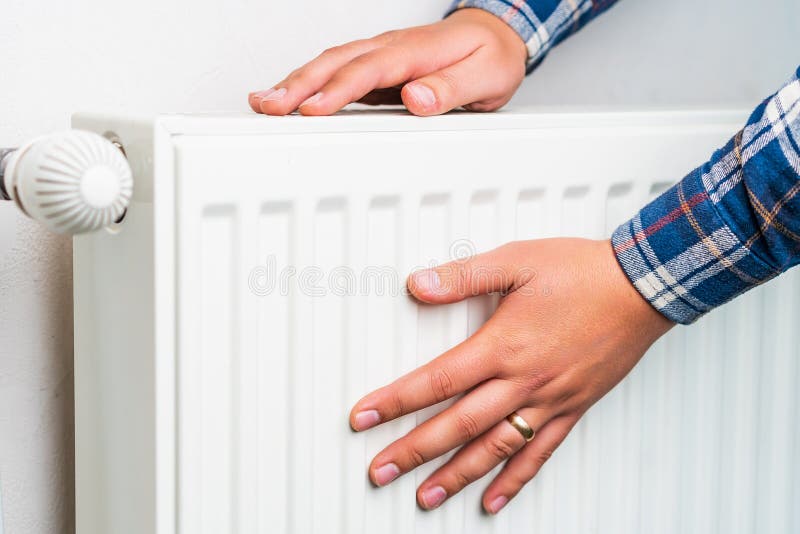 Hands on the Radiator of the Heating System, Selective Focus ...