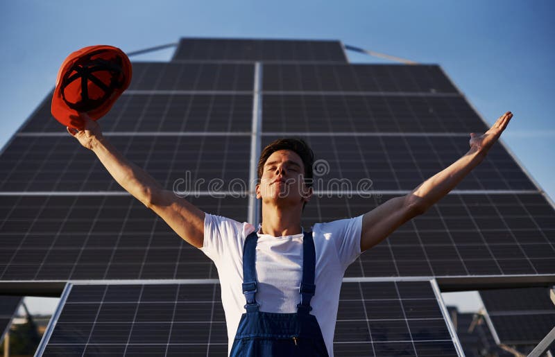 Hands Raised Up. Male Worker in Blue Uniform Outdoors with Solar ...