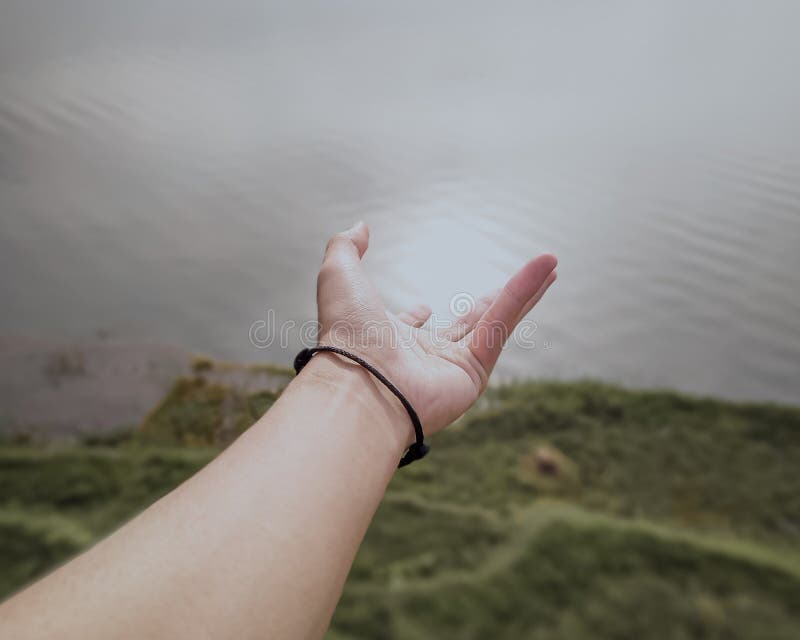 Hands Reaching for the Reflection of Sunlight from the Lake Stock Photo ...