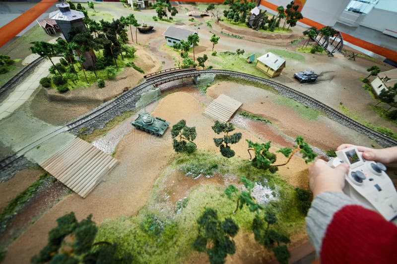 Hands with Remote Control Panel Above Miniature of Stock Photo - Image ...