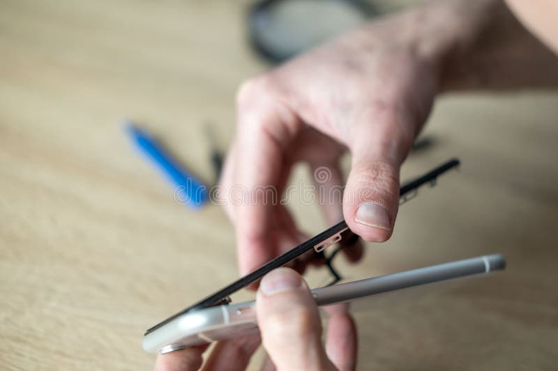 Hands Repairing Smartphone Hardware with Small Tools. Mobile Phone ...