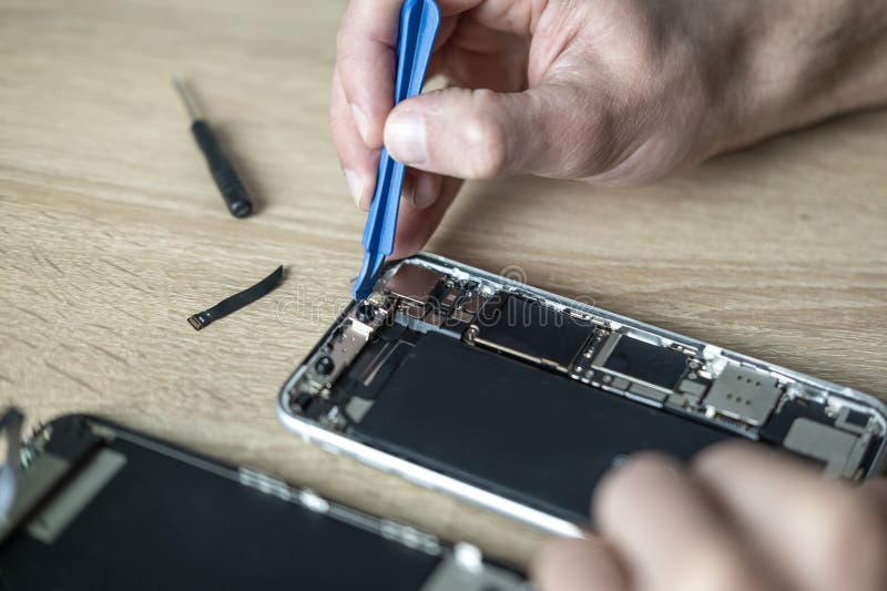 Hands Repairing Smartphone Hardware with Small Tools. Mobile Phone ...