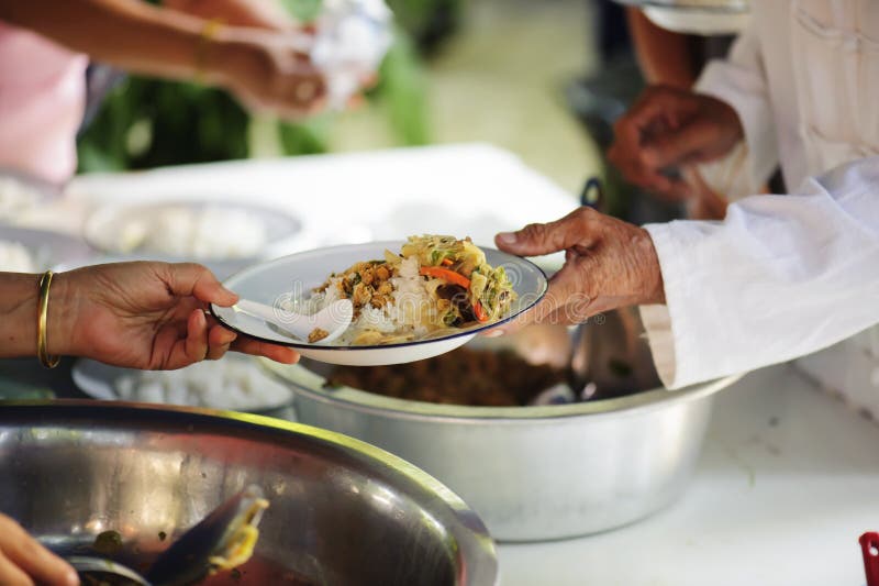 The Hands of the Rich are Giving Food To the Poor and Hungry Stock ...