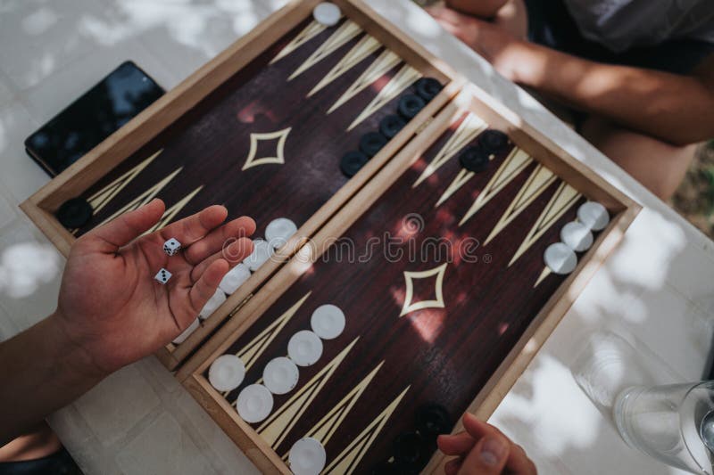 Hands Rolling Dice in Outdoor Backgammon Game Setup Stock Image - Image ...