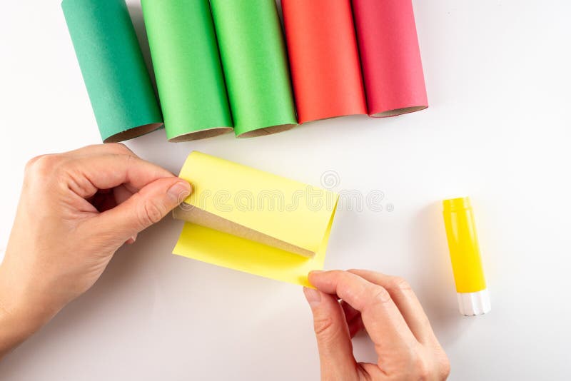 Hands Rolling Yellow Paper into Cylindrical Shape, Open Glue Stick ...