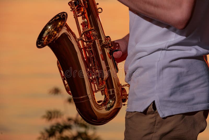 Hands and Saxophone Close Up. the Guy Plays a Wind Instrument Stock ...
