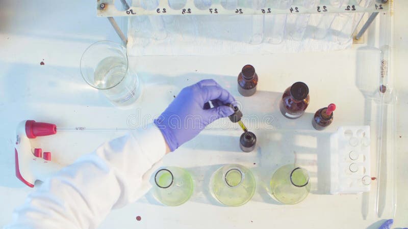 Hands of a Scientist Dropping a Reagent To Flasks Stock Footage - Video ...
