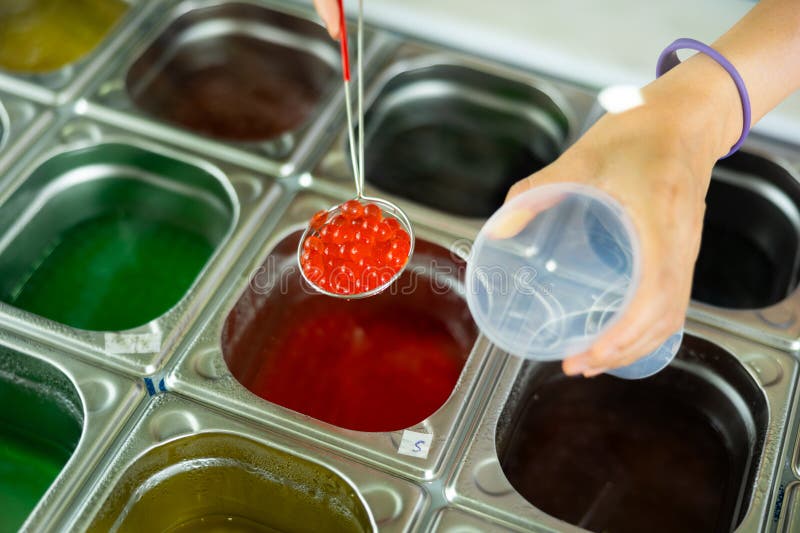 Hands Scooping Red Bubble Tea Pearls into Plastic Cup Stock Image ...