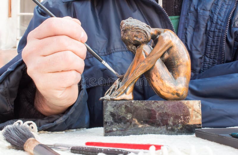 Hands of Sculptor Hold Copper Sculpture and Clean it with Brush Stock ...