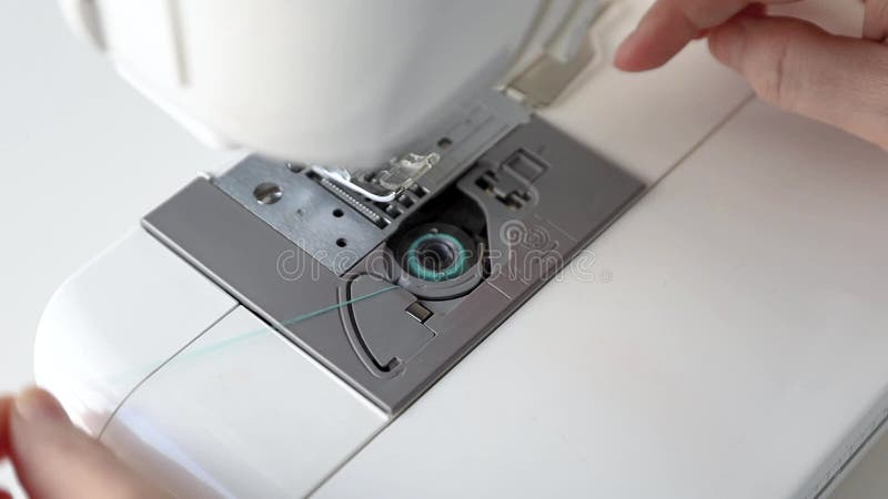 The Hands of a Seamstress Install a Hook with a Thread in a Sewing ...