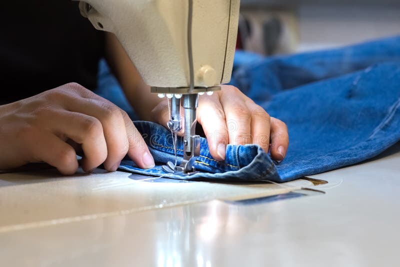 Hands of a Seamstress Work. with Her Sewing Machine Stock Image - Image ...
