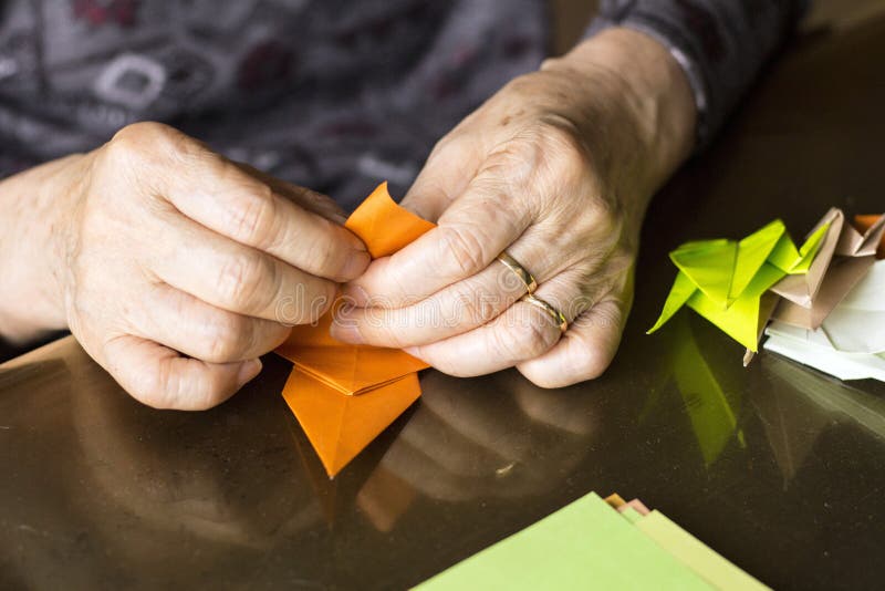 Hands of Senior Lady Folding Origami Paper Stock Photo - Image of ...