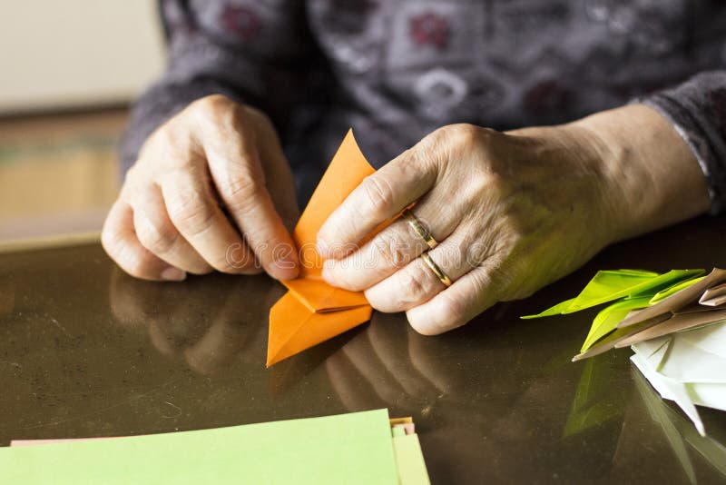 Hands of Senior Lady Folding Origami Paper Stock Image - Image of ...