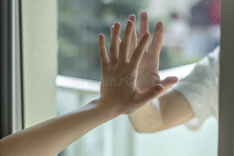 Hands Separated by a Glass Window for Social Distancing during the ...
