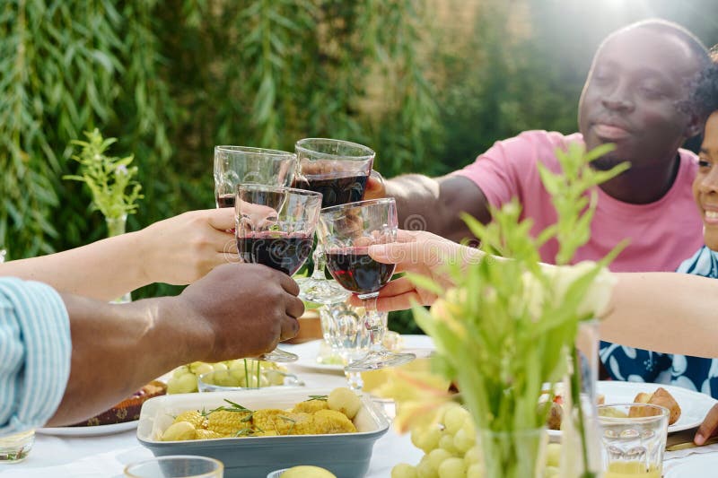 Hands of Several Intercultural Family Members with Drinks Clinking with ...