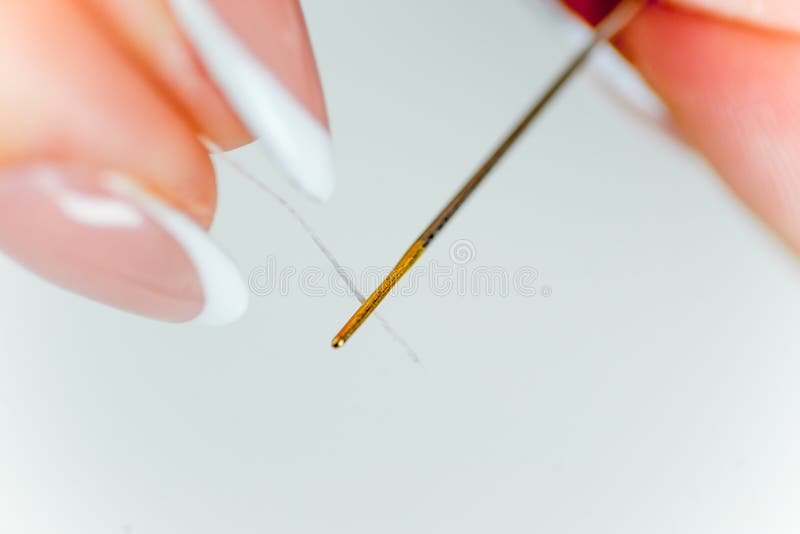 Hands are Sewing with Thread and Needle Stock Photo - Image of symbol ...