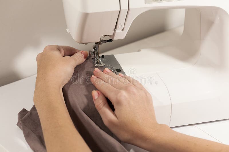 Hands Sewing on White Machine Brown Fabric Stock Image - Image of ...