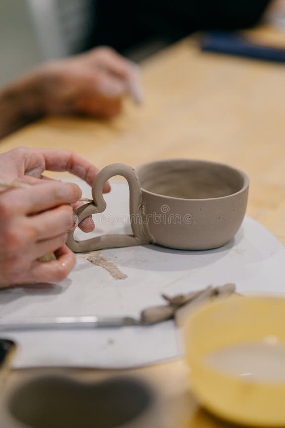 Hands Shaping Ceramic Mug with Heart-shaped Handle at Pottery Workshop ...