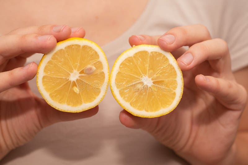 Hands Showcasing Half a Lemons. a Person& X27;s Fingers Displaying a ...