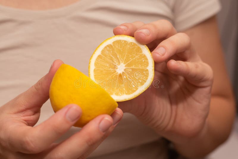Hands Showcasing Half a Lemons. a Person& X27;s Fingers Displaying a ...