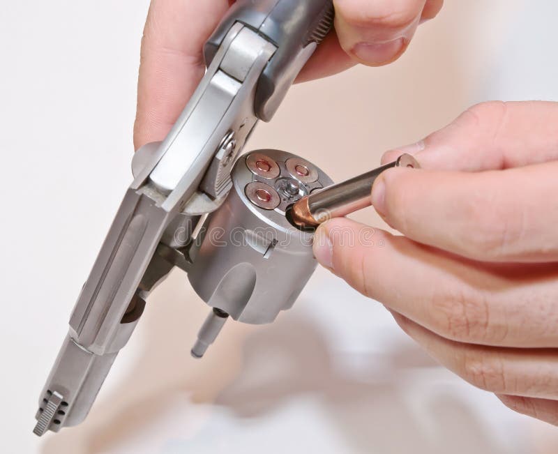 Hands Shown Loading a Revolver Stock Photo - Image of cylinder, casting ...