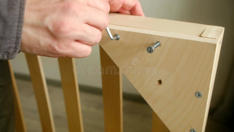 Hands Skillfully Assemble Bed Frame with Precision. Bolts Secured ...