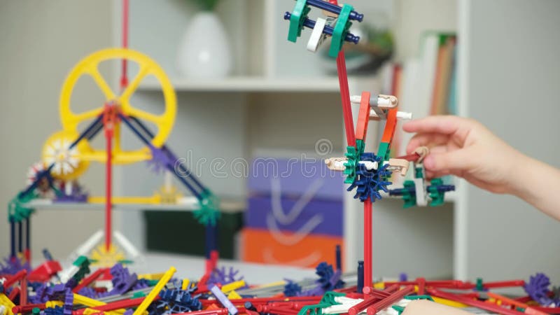 A Cute 5 Year Old Boy Creates Figures with a Magnetic Construction Kit ...