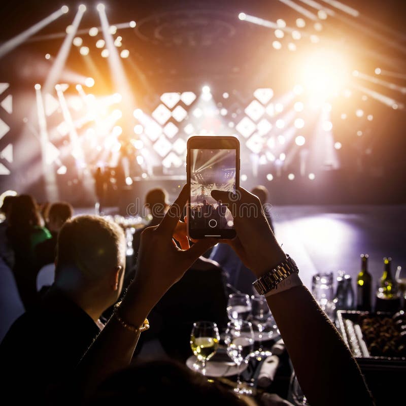 Hands with a Smartphone at the Concert Hall during Music and Light Show ...