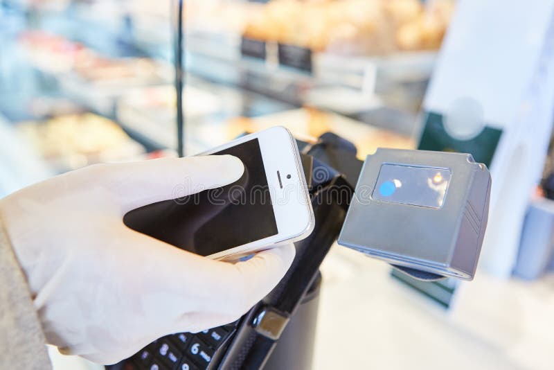 Hands with Smartphone for Mobile Payment at the Cash Register Stock ...