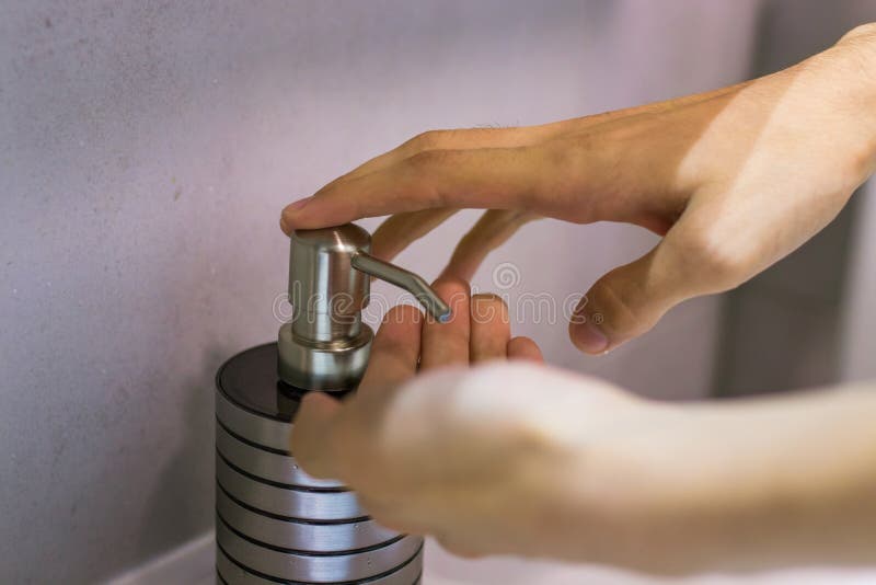 Hands with soap dispenser stock photo. Image of bathroom - 169669444