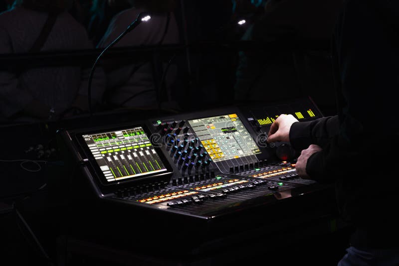 Hands of a Sound Engineer Working at a Mixing Console, Close-up Stock ...