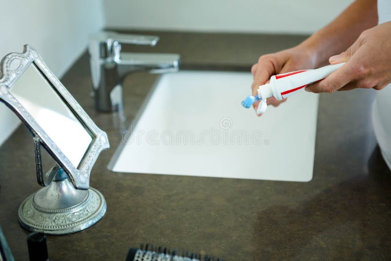 Hands Squeezing Toothpaste Onto a Toothbrush Stock Image - Image of ...