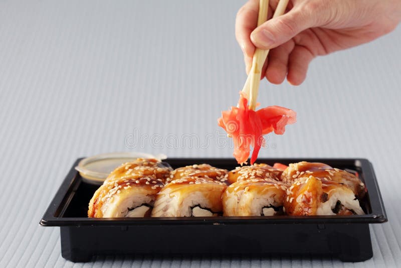 Hands sticks japan rolls stock image. Image of east, chopsticks - 47438845