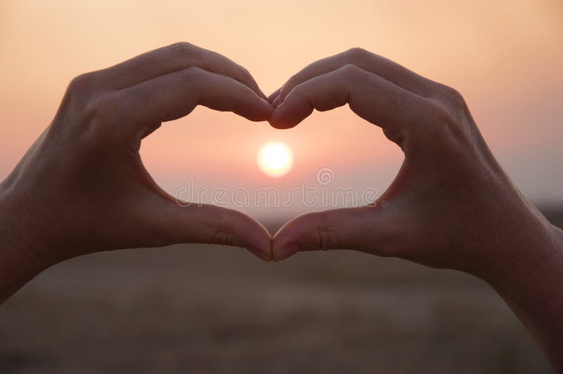 Hand Shaped Heart Against a Beautiful Sunset Stock Photo - Image of ...