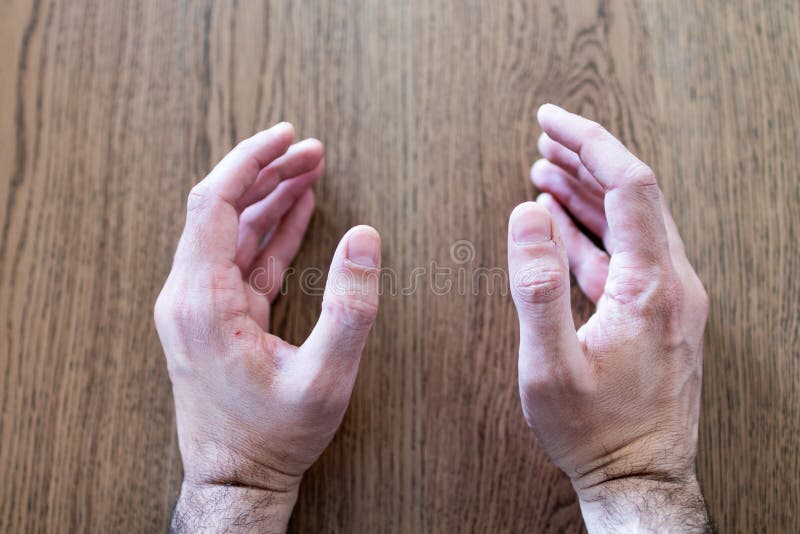 Hands on Table in a Pose To Simulate Holding Something. Hands Open and ...