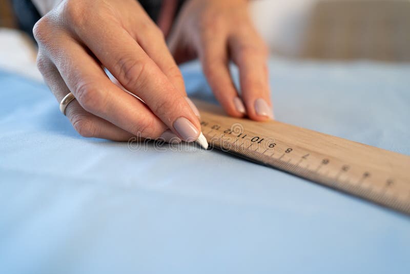 Hands of Tailor Using White Chalk and Ruler when Drawing Detail on ...