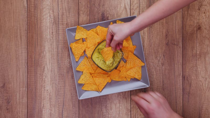 Hands Taking Delicious Tortilla Chips from a Rotating Plate Stock Video ...