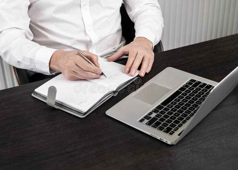 Hands Taking Notes, Writing in Planner at Office Desk with Laptop Stock ...
