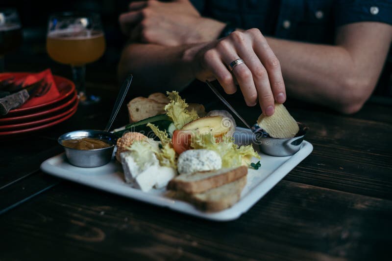 Hands Taking Snacks from the Plate on Wooden Table Stock Photo - Image ...