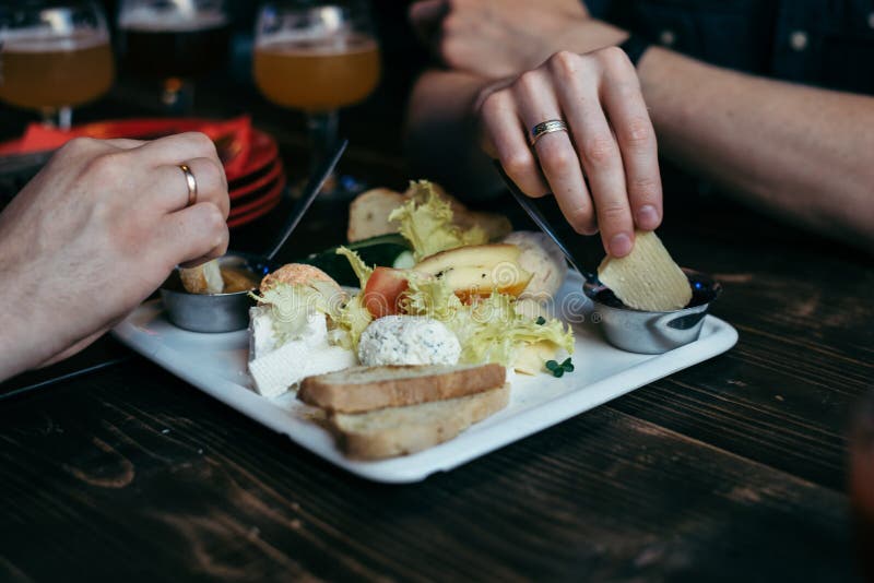 Hands Taking Snacks from the Plate on Wooden Table Stock Image - Image ...