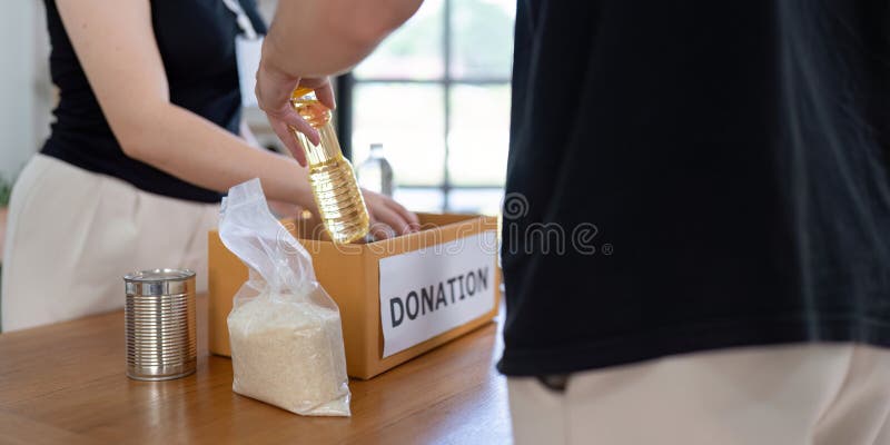 Hands on Team Packing Essential Groceries for Donation Box Stock Image ...