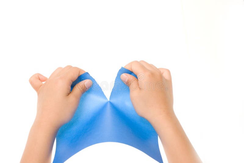 Hands Tearing Blue Paper Stock Photography - Image: 23663122