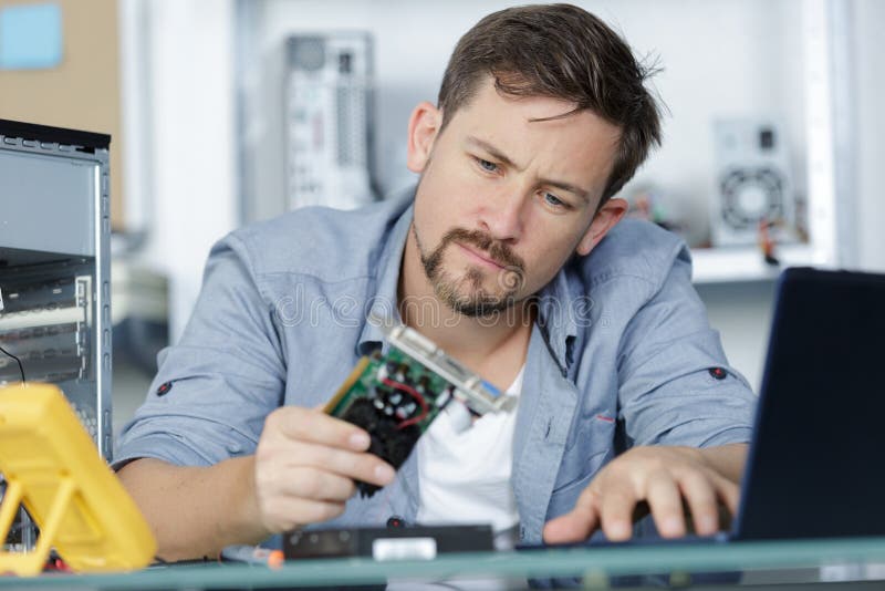 Hands of Technician Installing a Graphics Adapter Card on the Computer ...